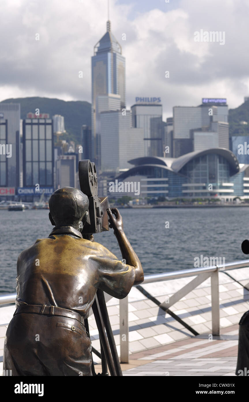 Statue of cameraman with skyline of Hong Kong and Hong Kong Convention ...