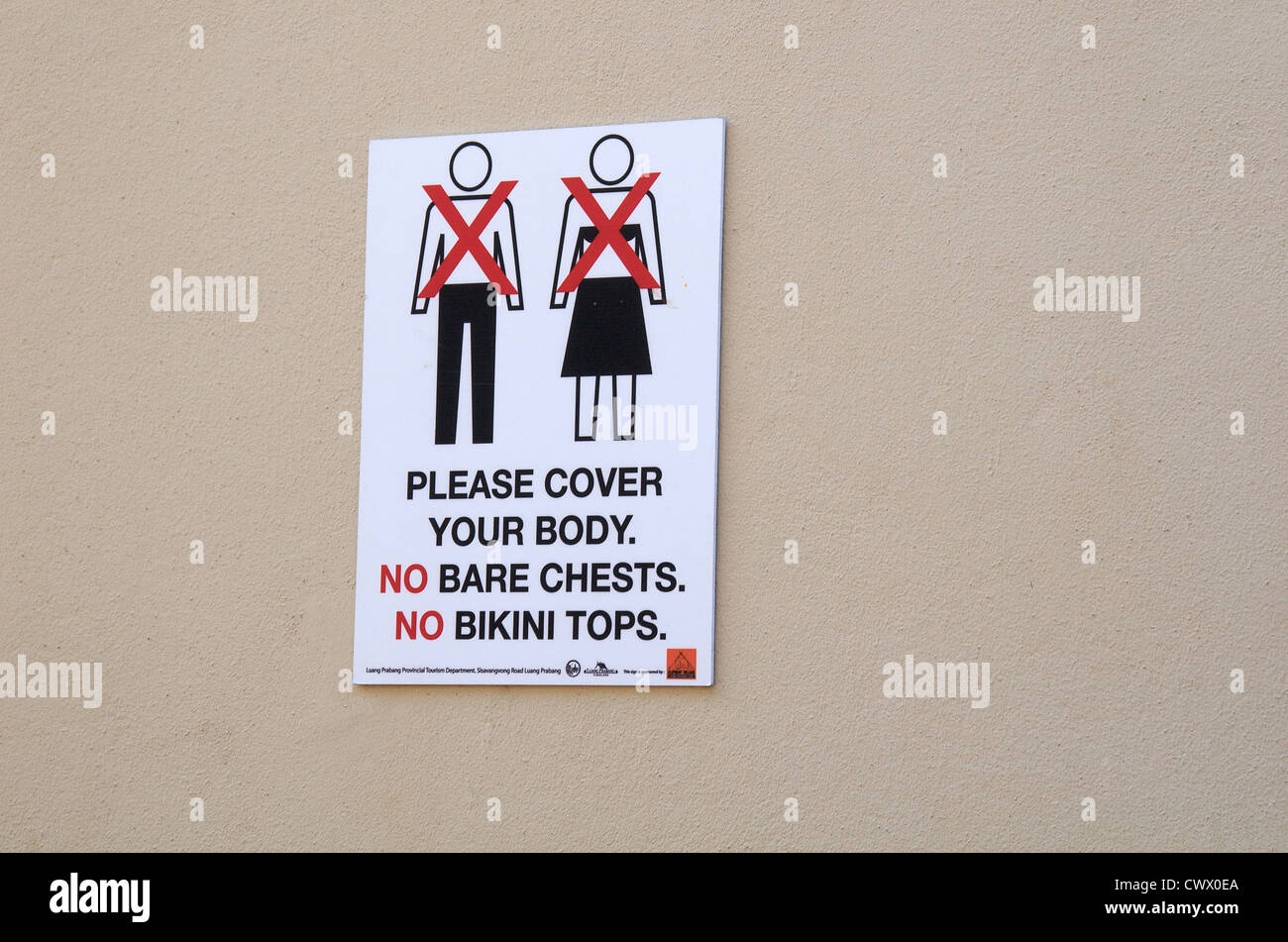 street sign on house wall " please cover your body no bare chests no ...