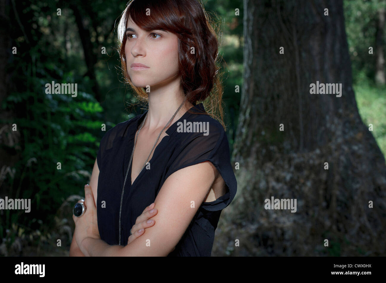 Woman standing in forest Stock Photo - Alamy