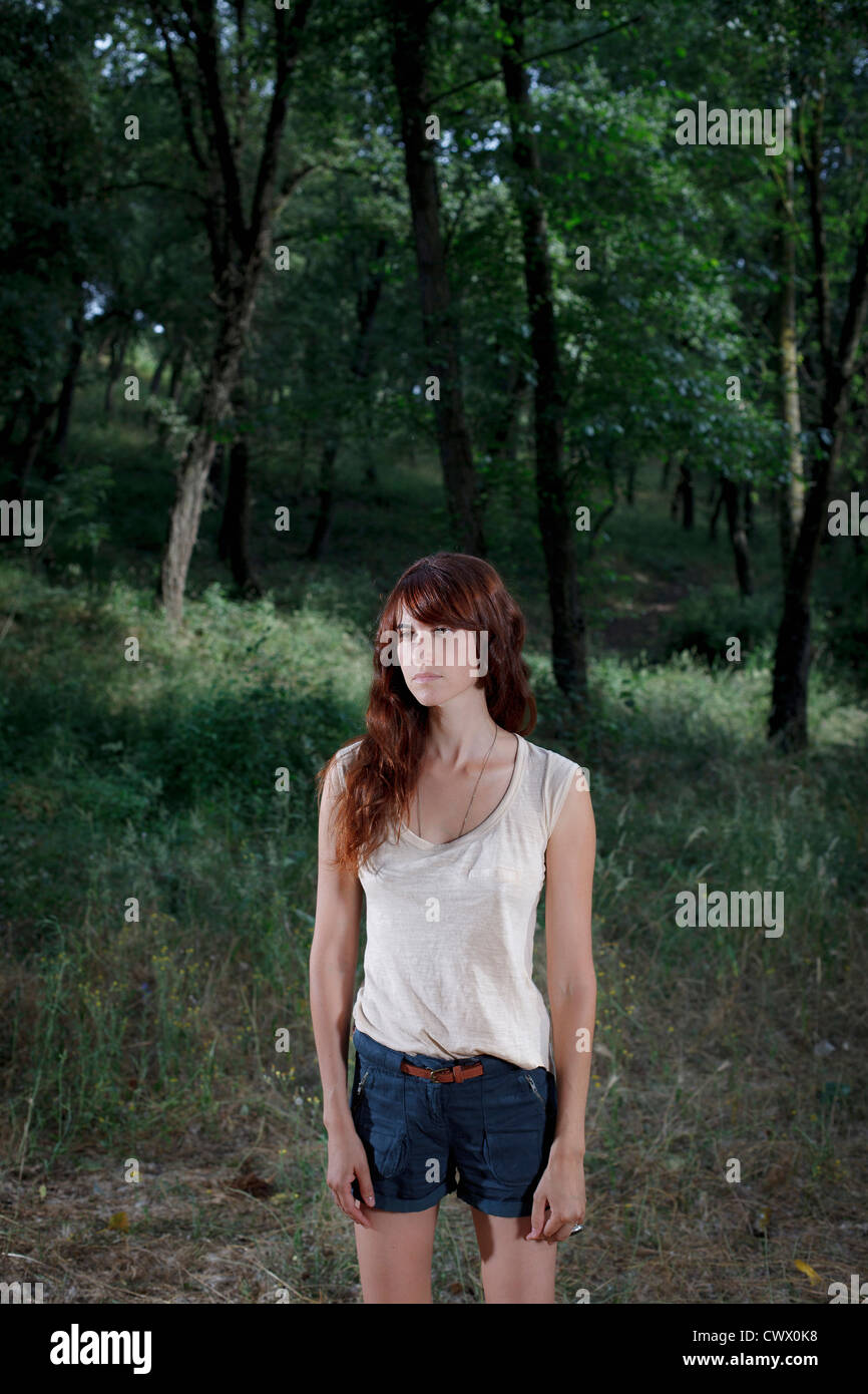 Woman standing in forest Stock Photo - Alamy