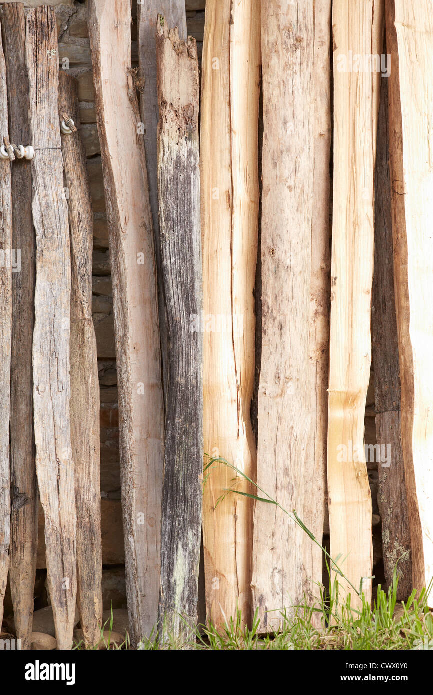 old wooden staves derelict rust wood slats brick stone wall green grass ...