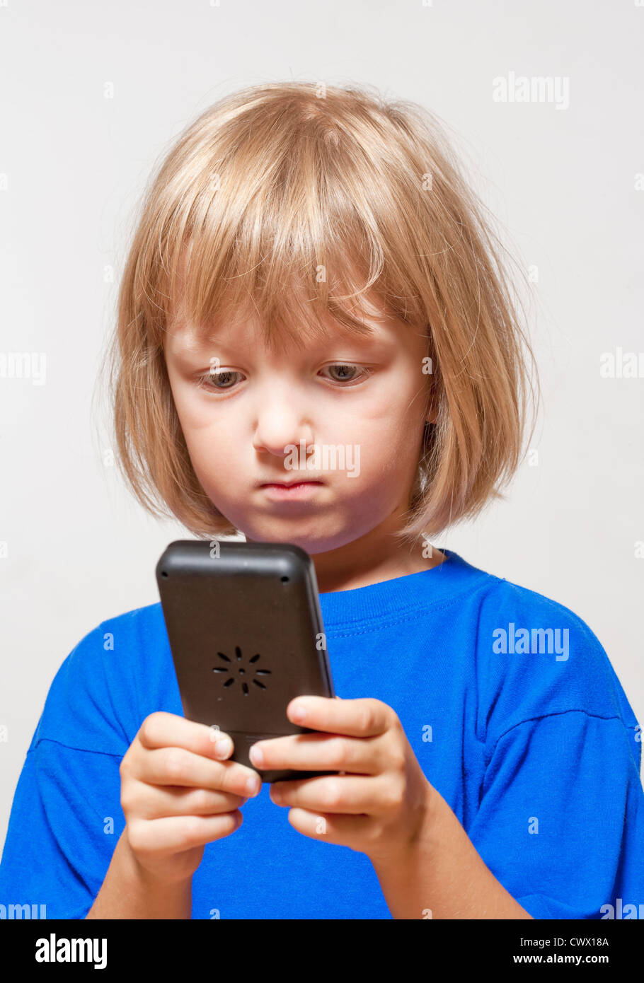 boy playing with handheld computer game - isolated on light gray Stock ...