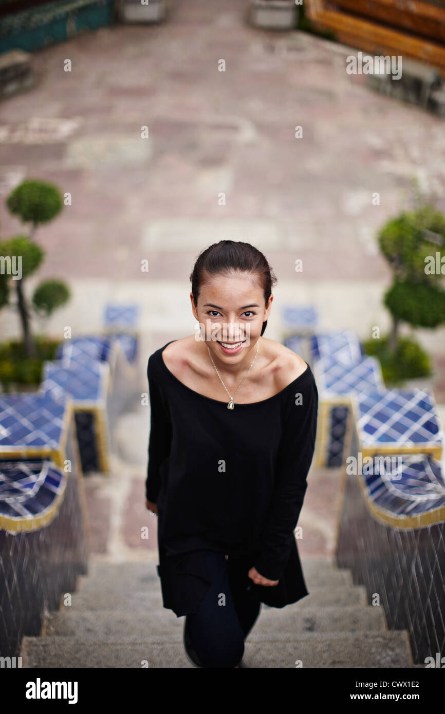 Woman smiling on ornate steps Stock Photo - Alamy