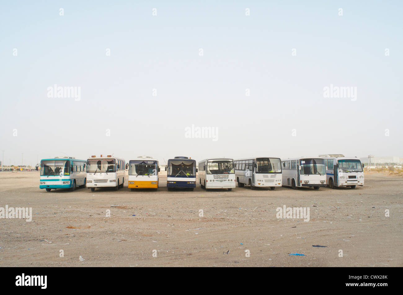Tour buses parked in dirt lot Stock Photo - Alamy
