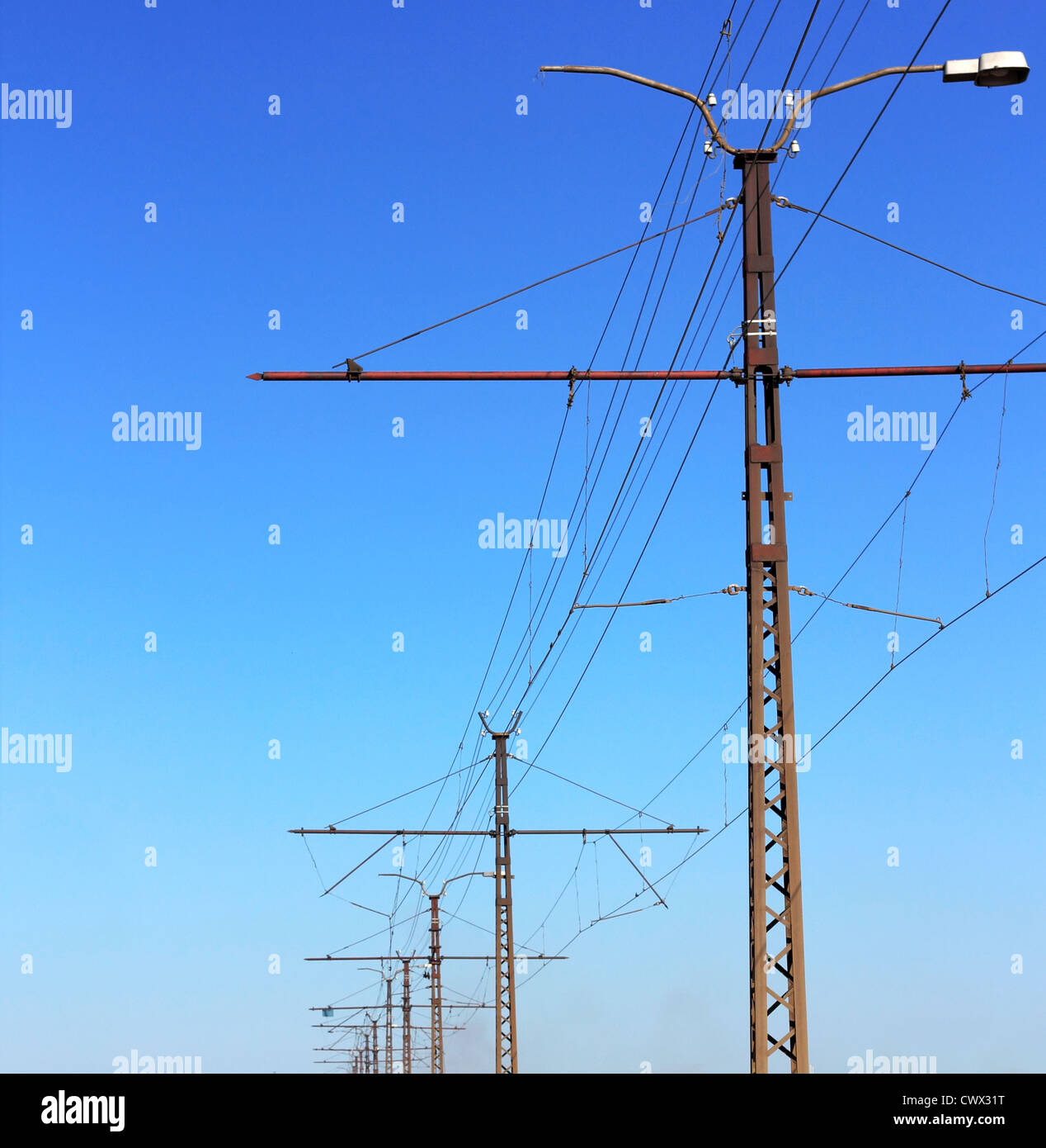Railroad railway catenary lines against clear blue sky Stock Photo - Alamy