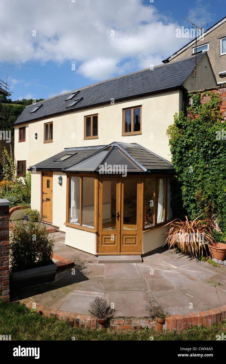 A renovated cottage with matching render slate tiles and stained wood ...