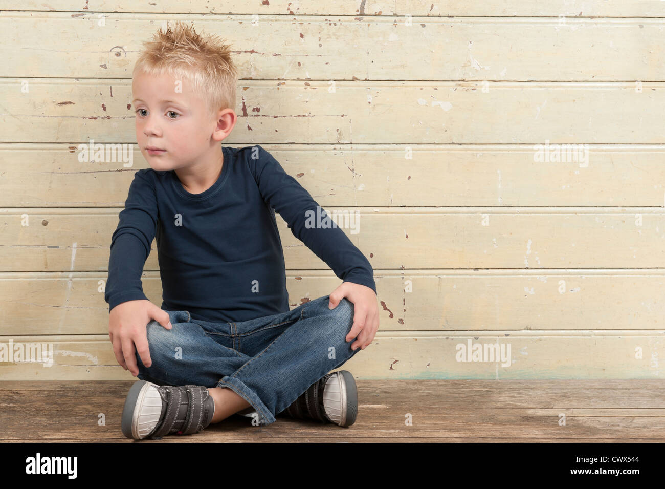 Boy seated hi-res stock photography and images - Alamy