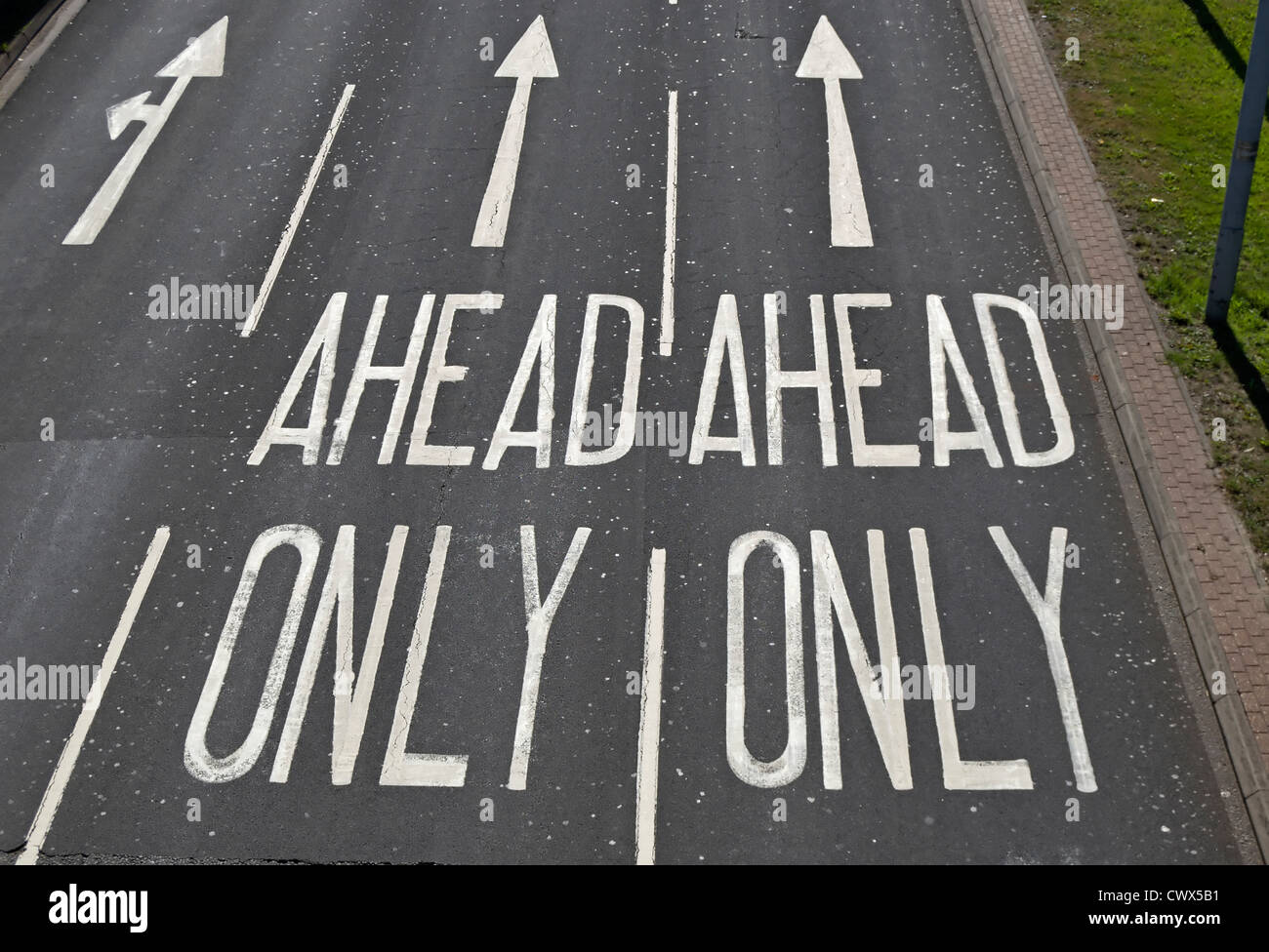 ahead only road markings on two lanes of a three lane road Stock Photo ...