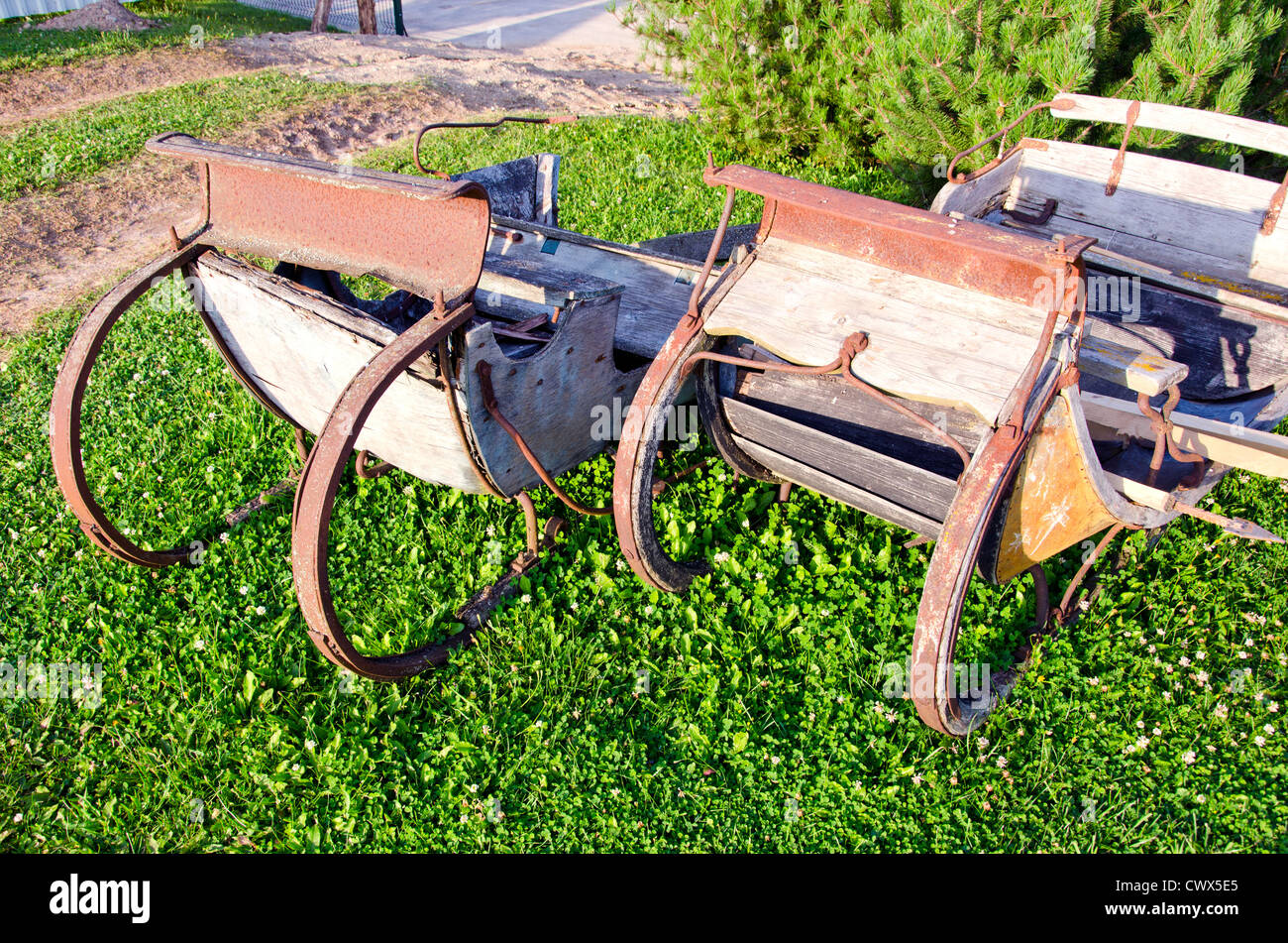 two historical horse sledge in farm on grass Stock Photo - Alamy