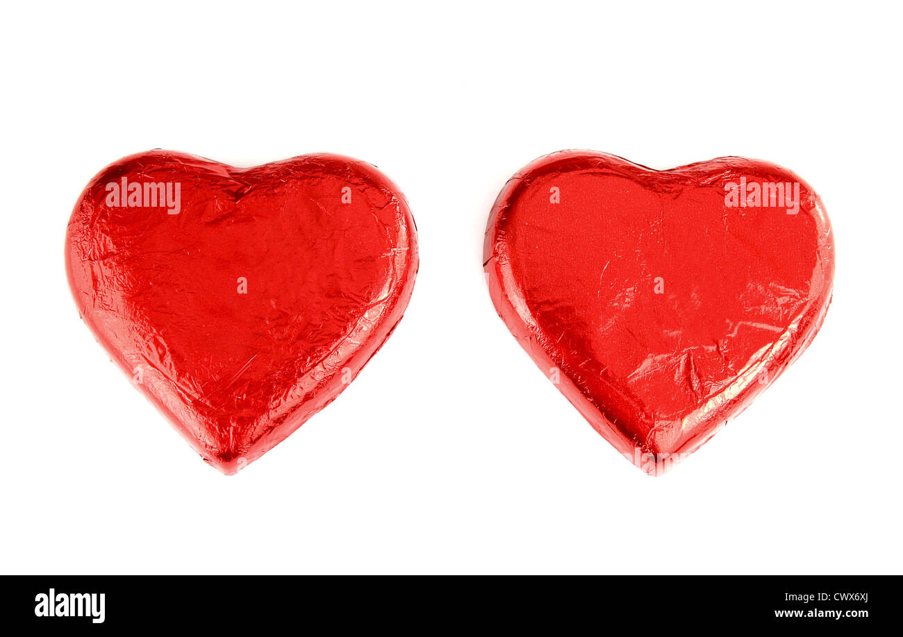 Red Foil wrapped chocolate hearts Stock Photo - Alamy