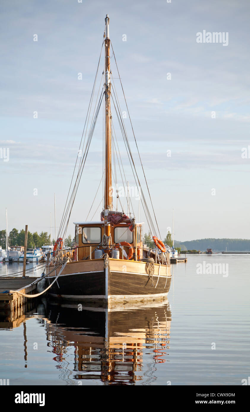 Old fashioned wooden yacht moored in small European marina. Imatra town ...