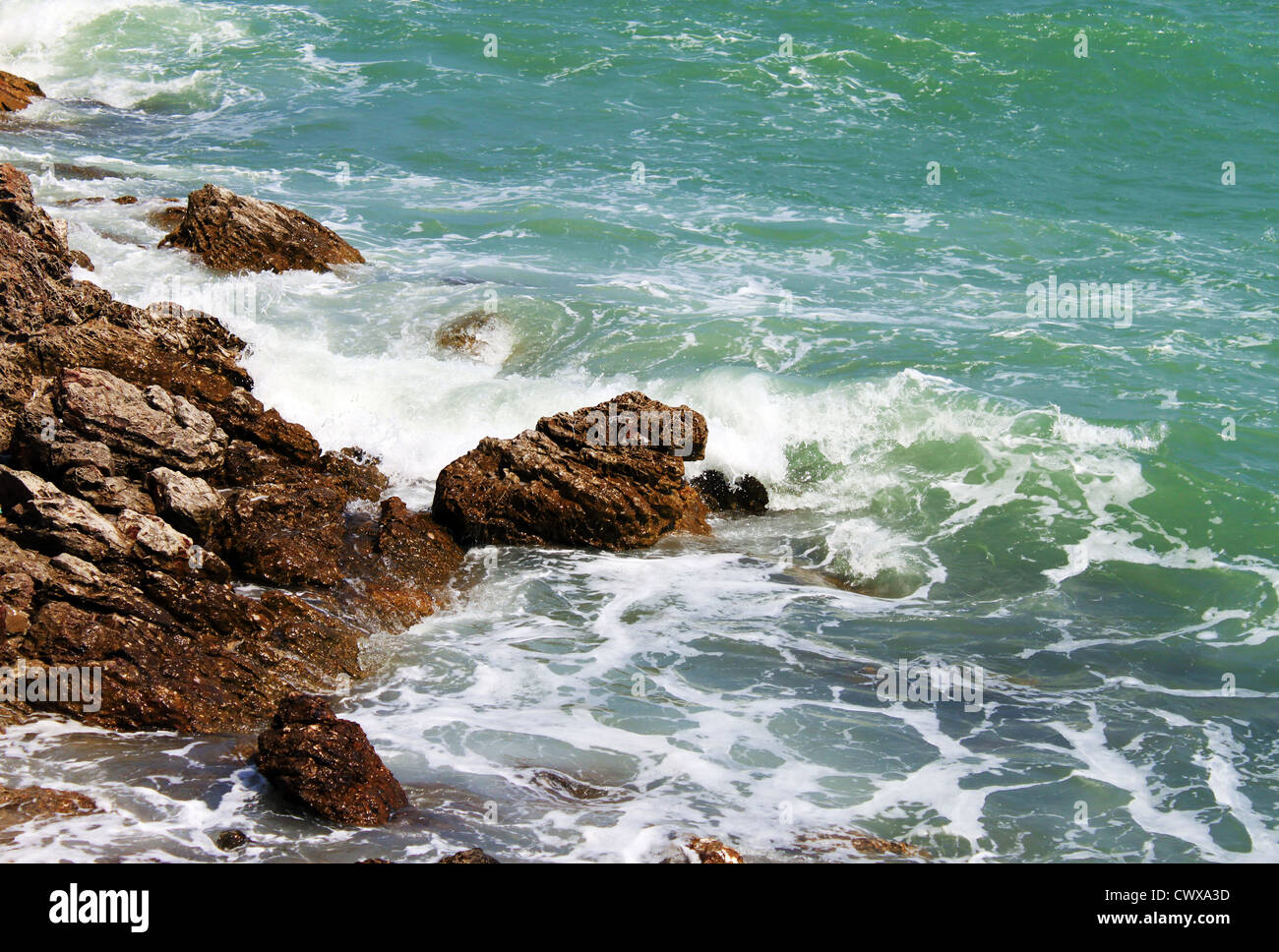 Sea stones splash wave Stock Photo - Alamy