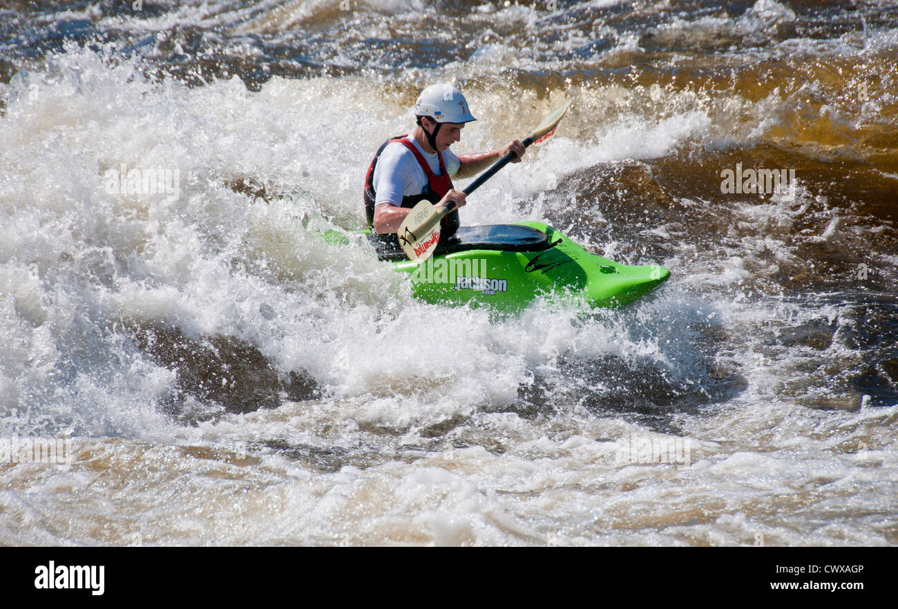 Young caucasian adult male wearing a white crash helmet in a green ...