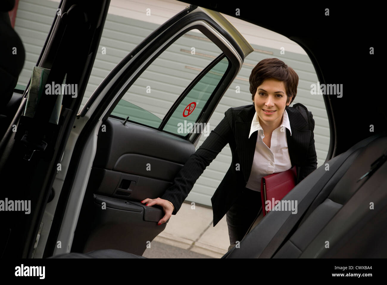 A business woman gets in the cab Stock Photo - Alamy