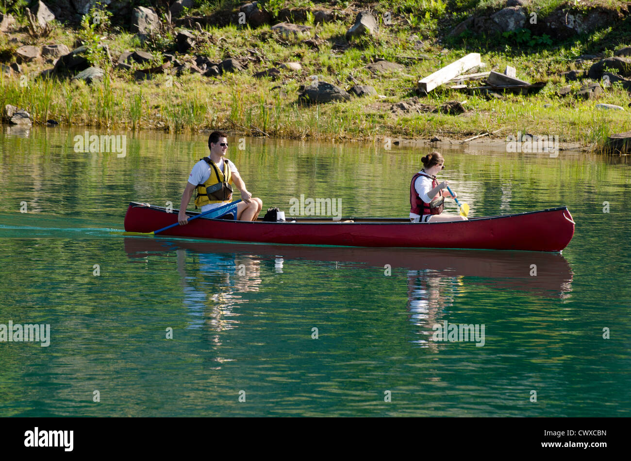 Young couple in a red canoe Stock Photo - Alamy