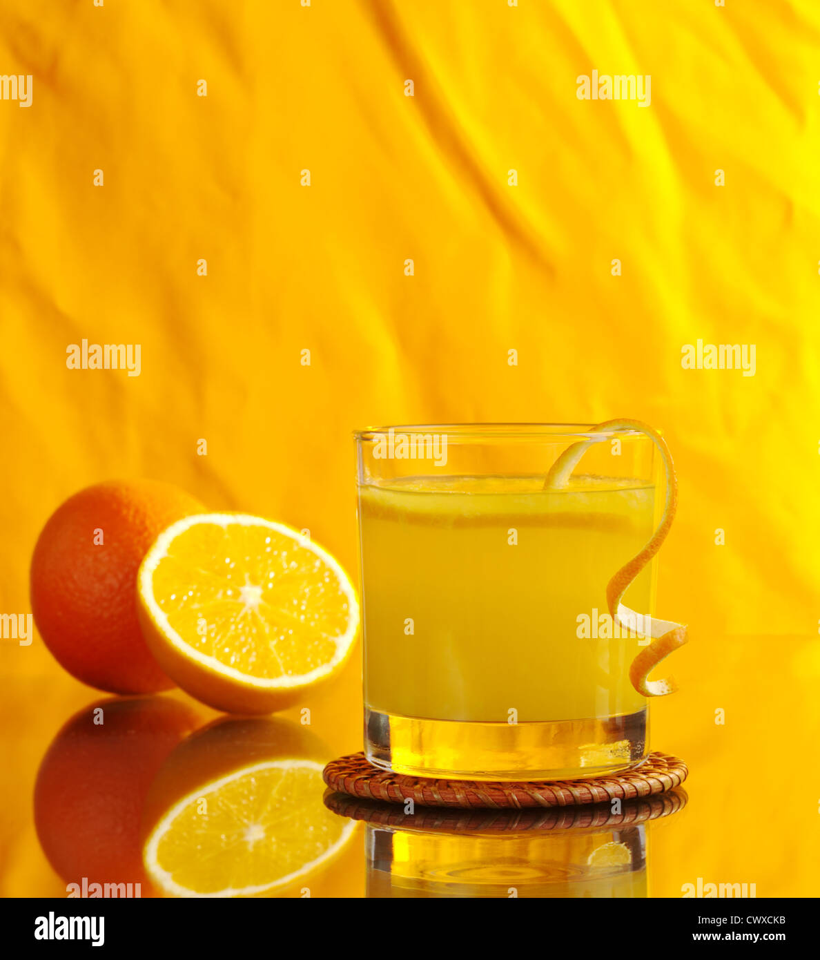 Freshly squeezed orange juice in glass with orange peel and oranges on ...