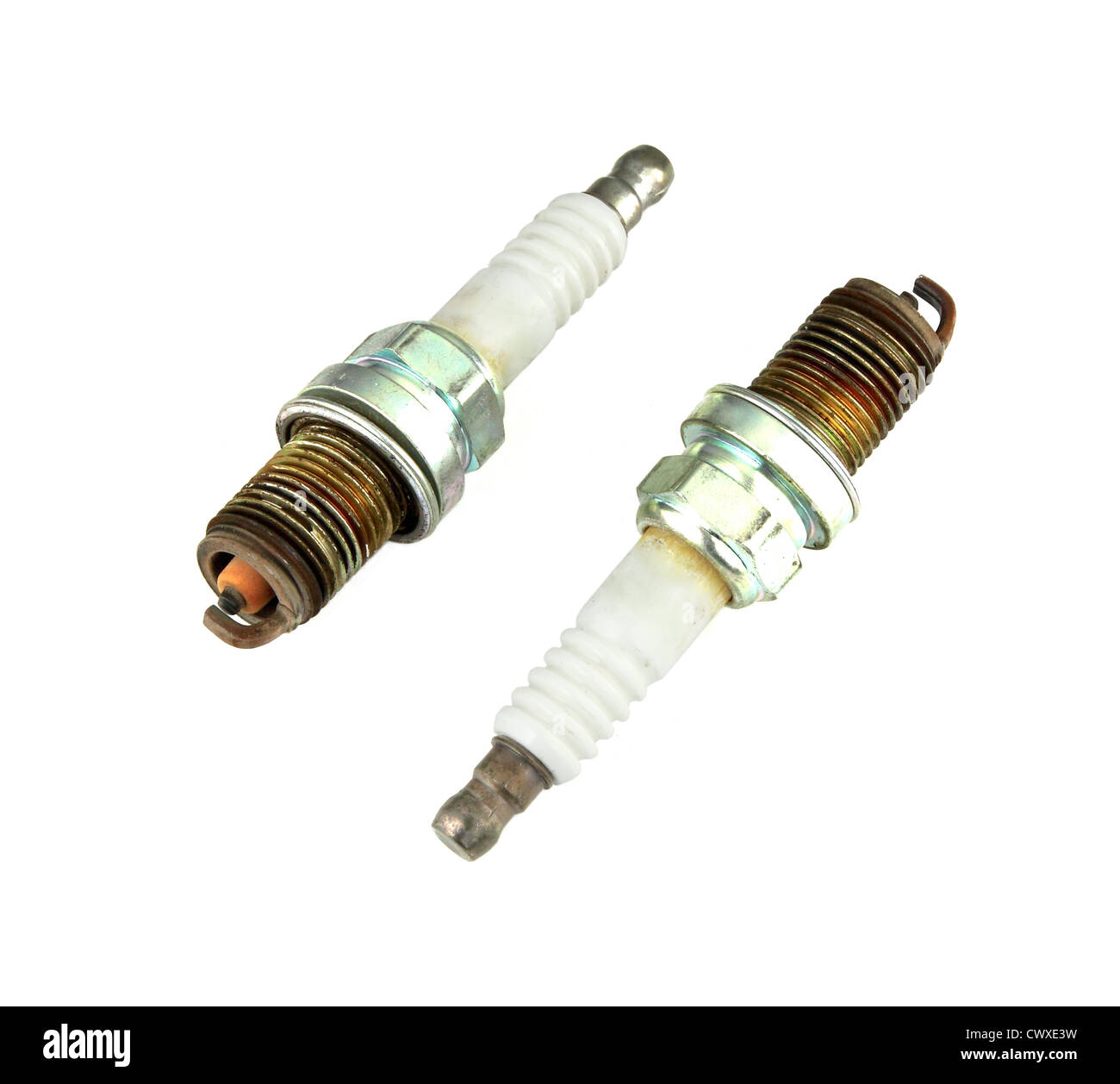 two old burned spark plug on white background Stock Photo - Alamy