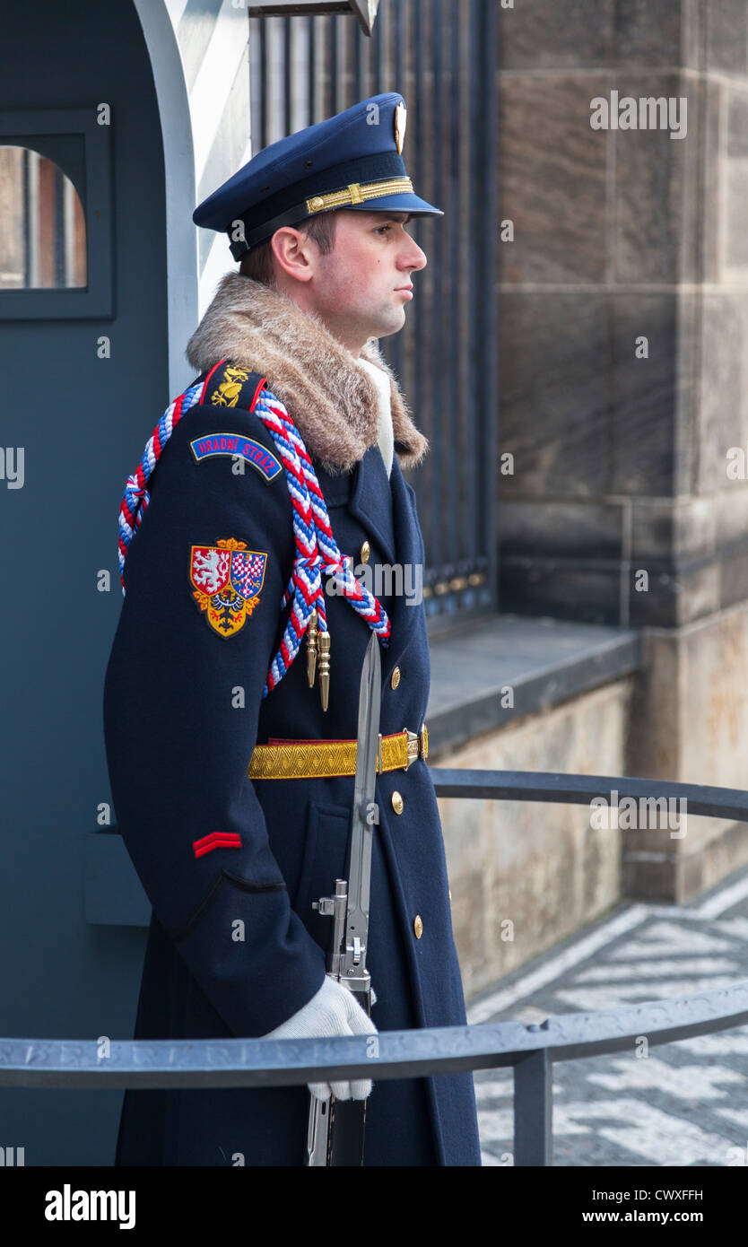 Guard at Prague Castle with peaked cap and colourful braids standing to ...