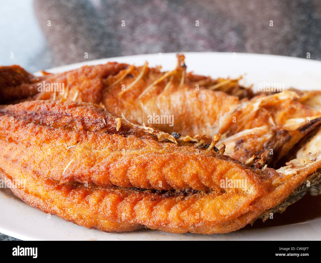 Fried snapper at a seafood restaurant in Thailand. Shallow depth of ...