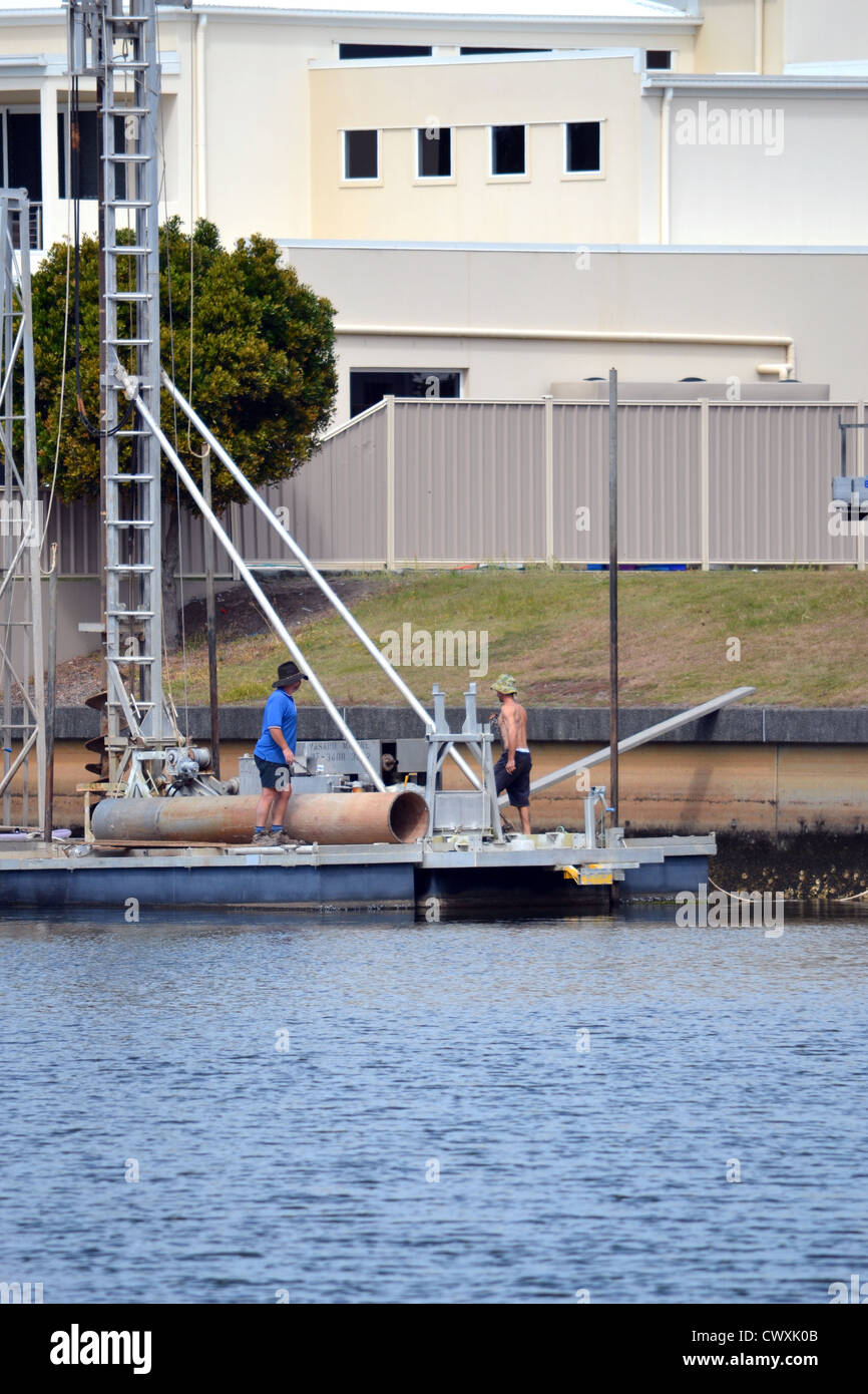 Two men working on a pontoon on the canal Stock Photo - Alamy