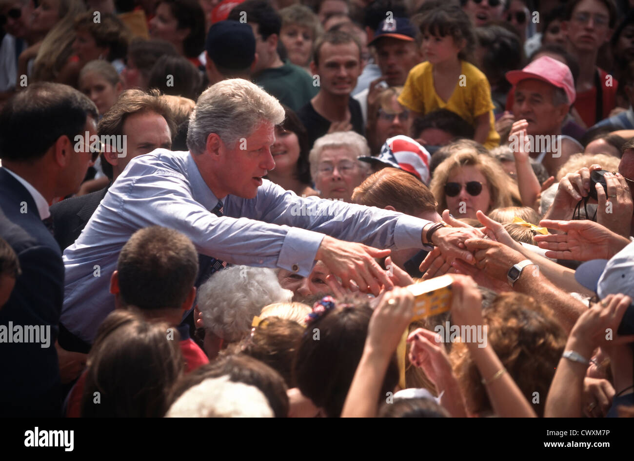 President Bill Clinton shakes hands with supporters during a campaign ...