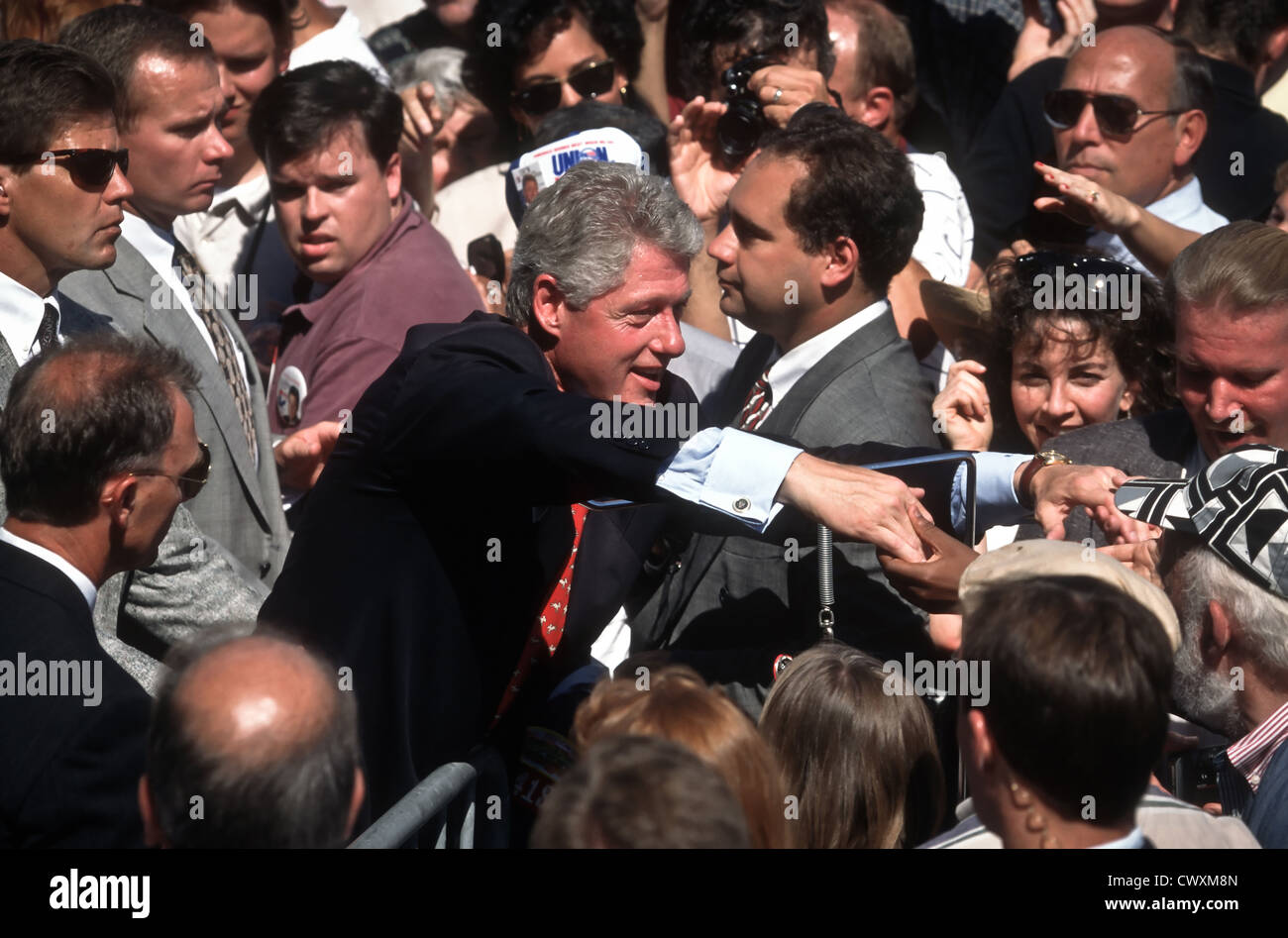 President Bill Clinton shakes hands with supporters during a campaign ...