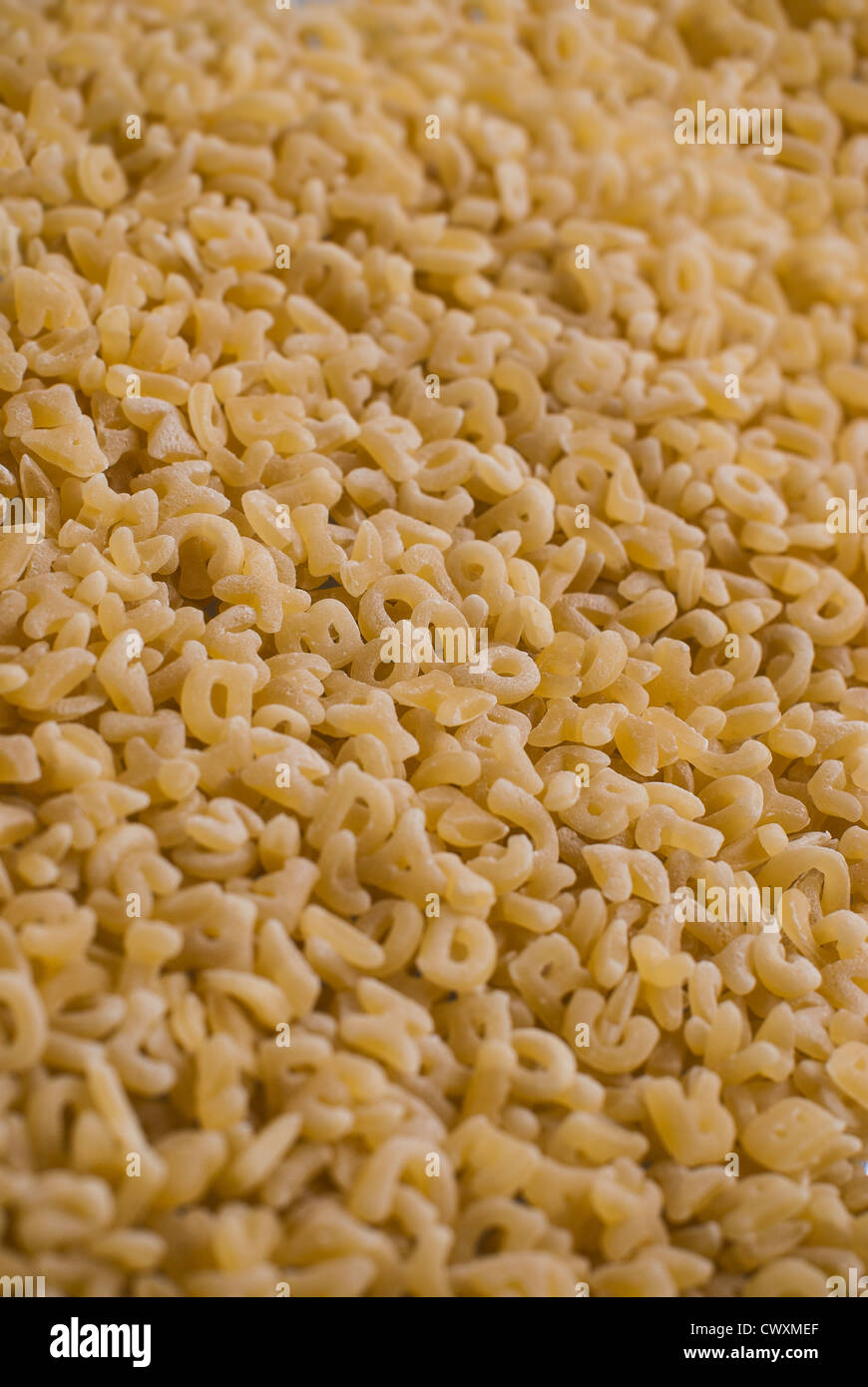 Close-up background of alphabet noodle showing letters Stock Photo - Alamy