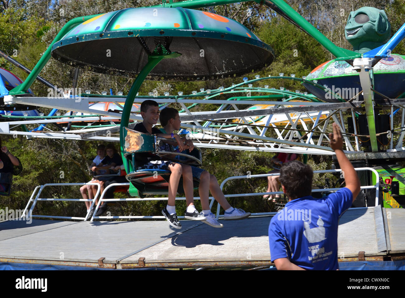 Children on the "Alien Invader" ride at carnival Stock Photo - Alamy