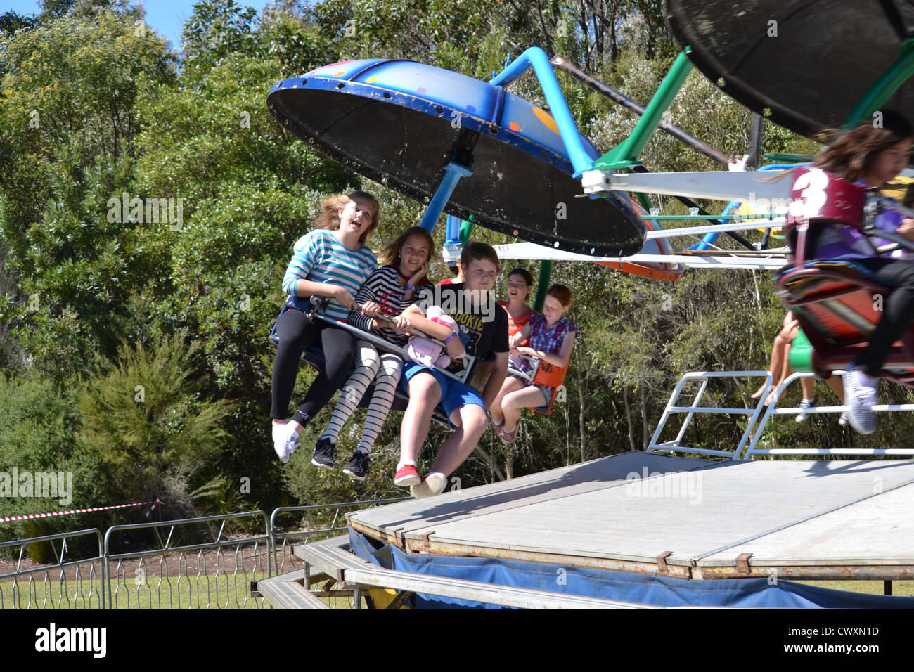 Children on the "Alien Invader" ride at carnival Stock Photo - Alamy