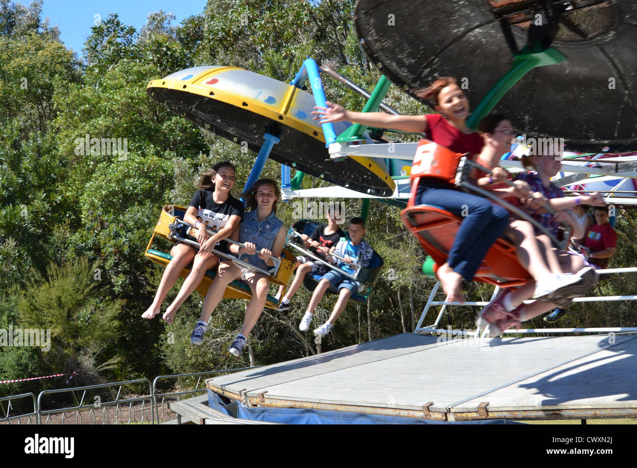 Children on the "Alien Invader" ride at carnival Stock Photo - Alamy