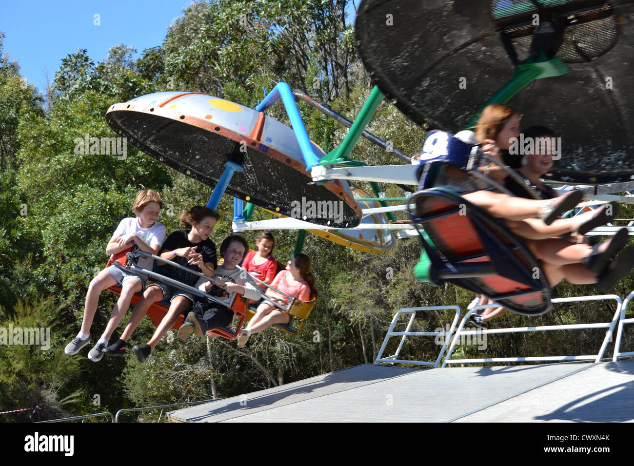 Children on the "Alien Invader" ride at carnival Stock Photo - Alamy