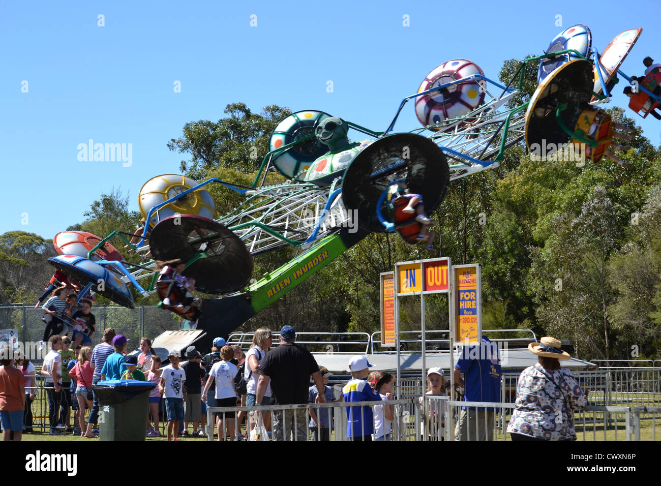 People watching and waiting for their turn on the "alien invader" ride ...