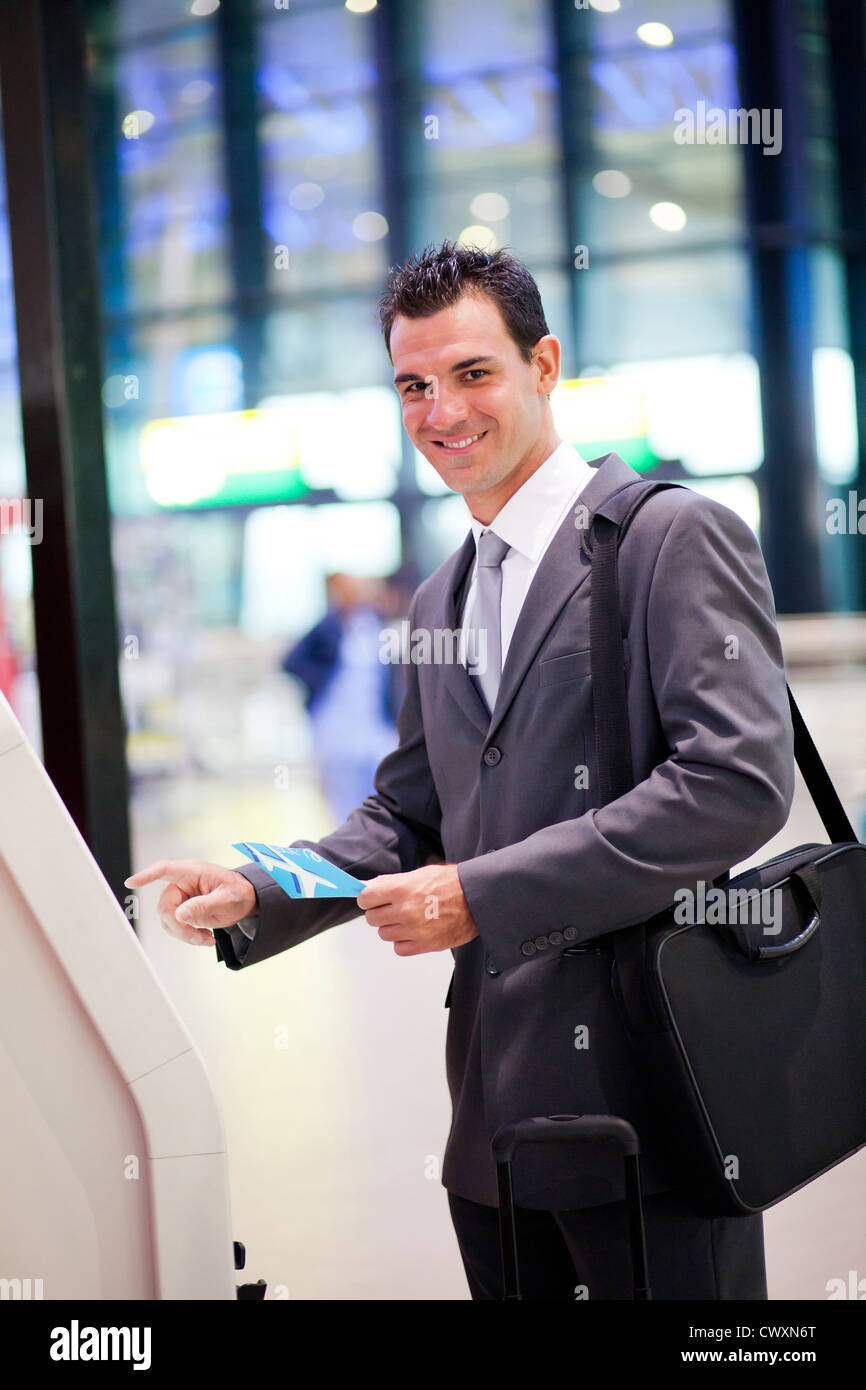 businessman using self help check in machine at airport Stock Photo - Alamy