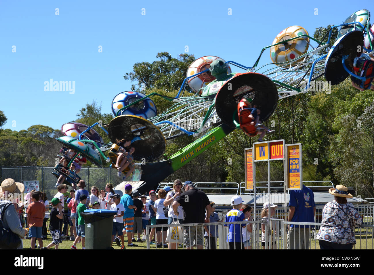 People watching and waiting for their turn on the "alien invader" ride ...