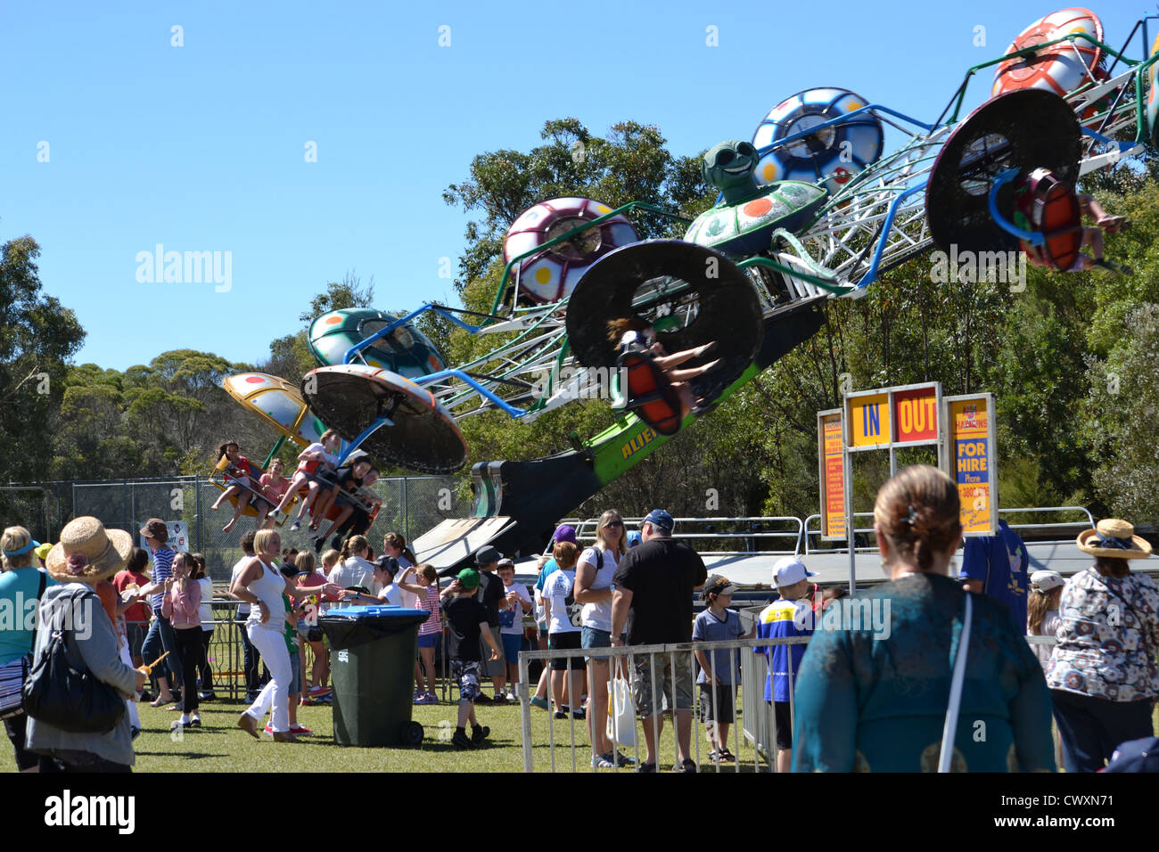 People watching and waiting for their turn on the "alien invader" ride ...