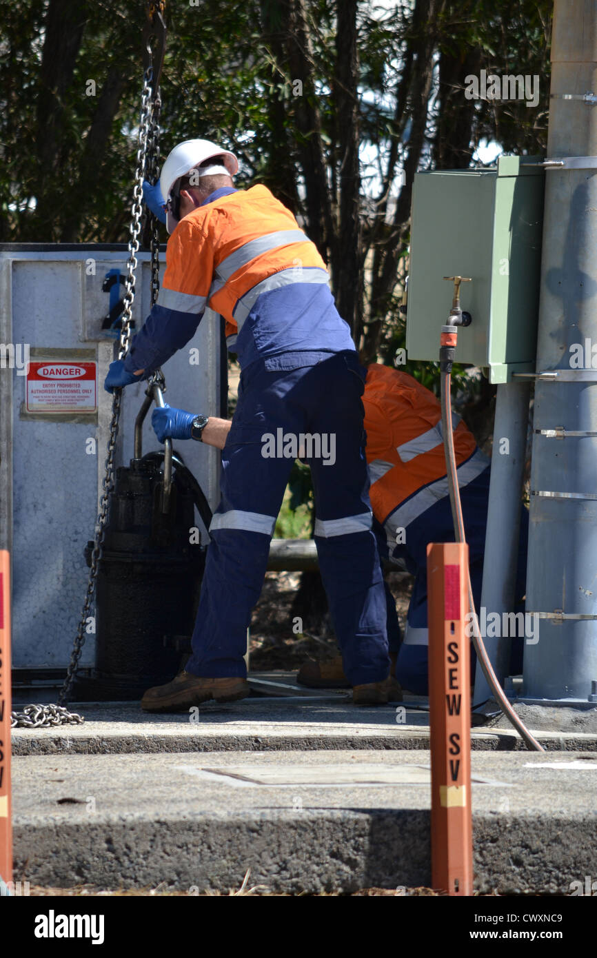 two men inspect a sewer main Stock Photo - Alamy