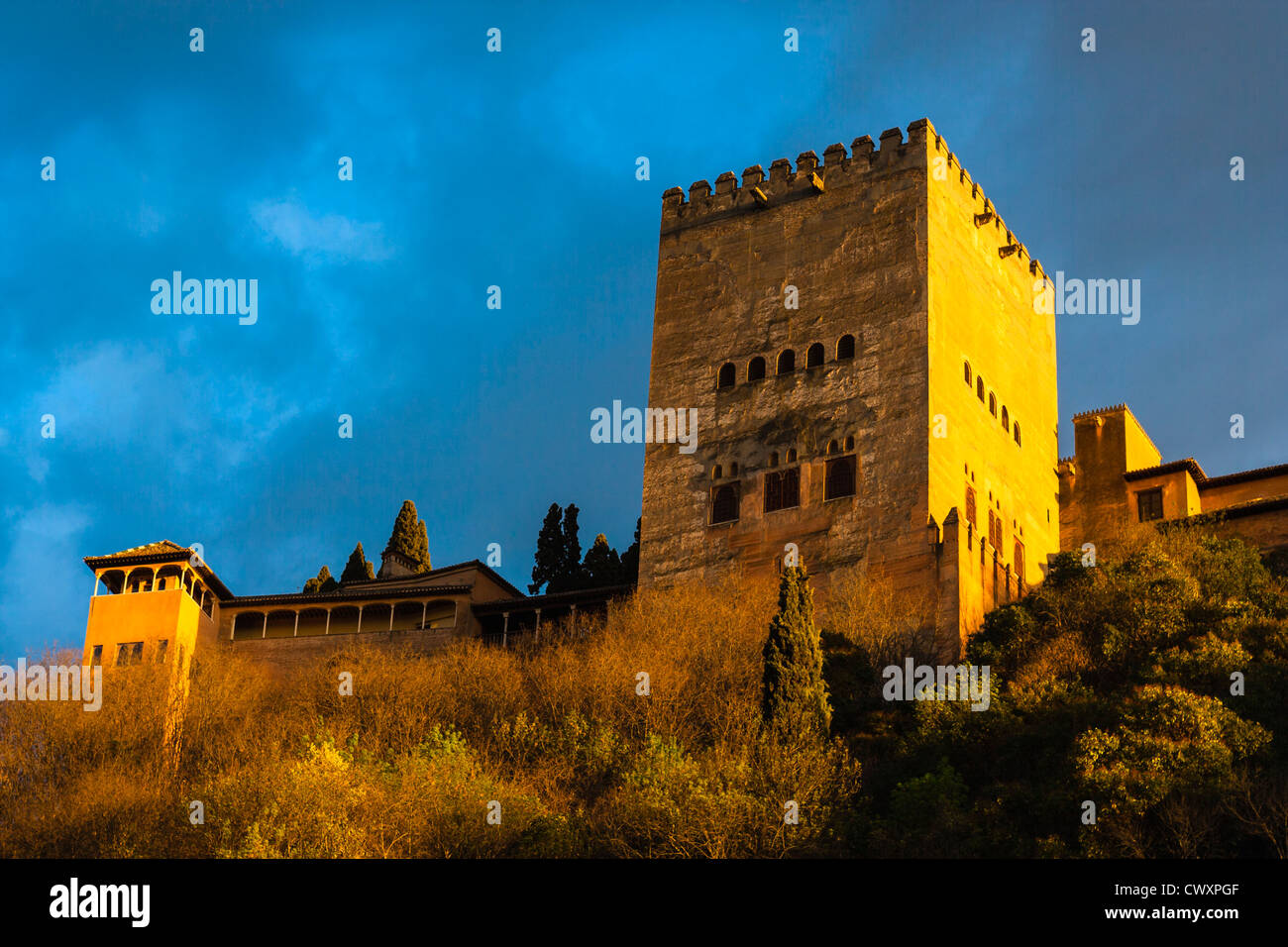 Alhambra palace with Comares tower illuminated by warm sunset light ...