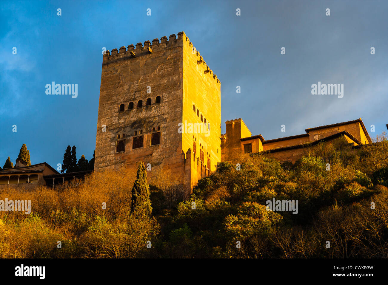 Alhambra palace with Comares tower illuminated by warm sunset light ...