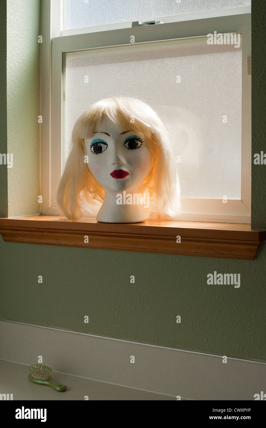 Woman's Mannequin head along window sill with brush Stock Photo - Alamy