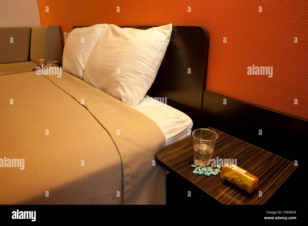 Motel room with bed and medications on side table near bed Stock Photo ...