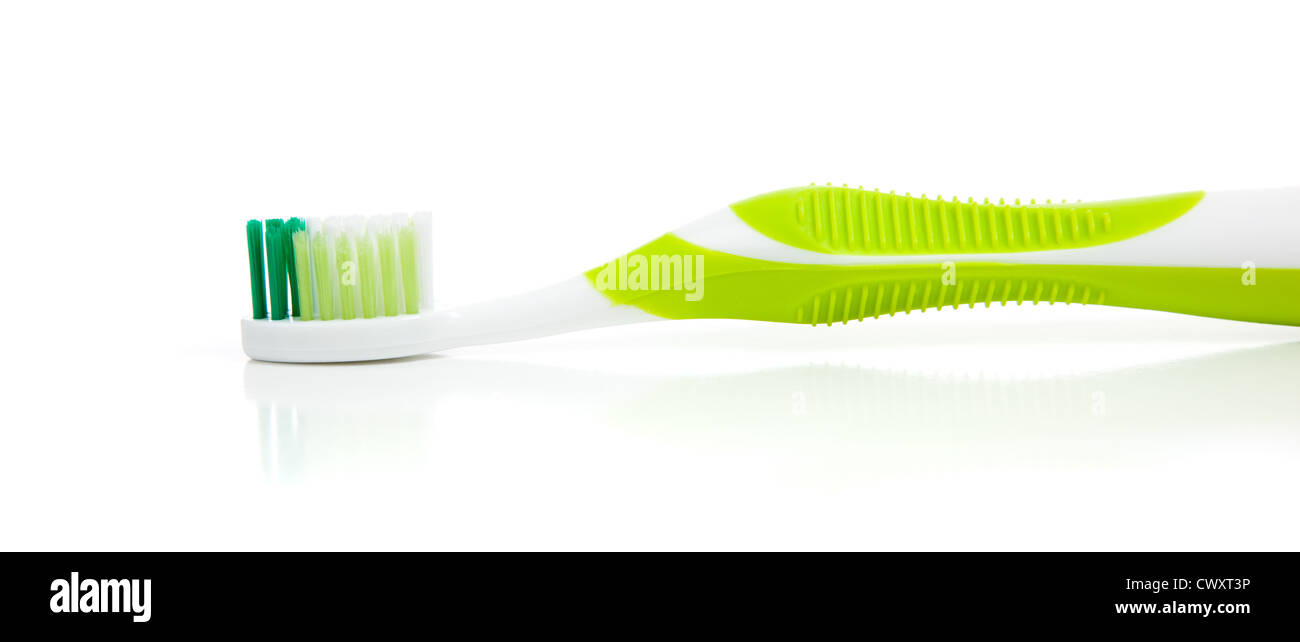 A lime green toothbrush on a white background Stock Photo - Alamy