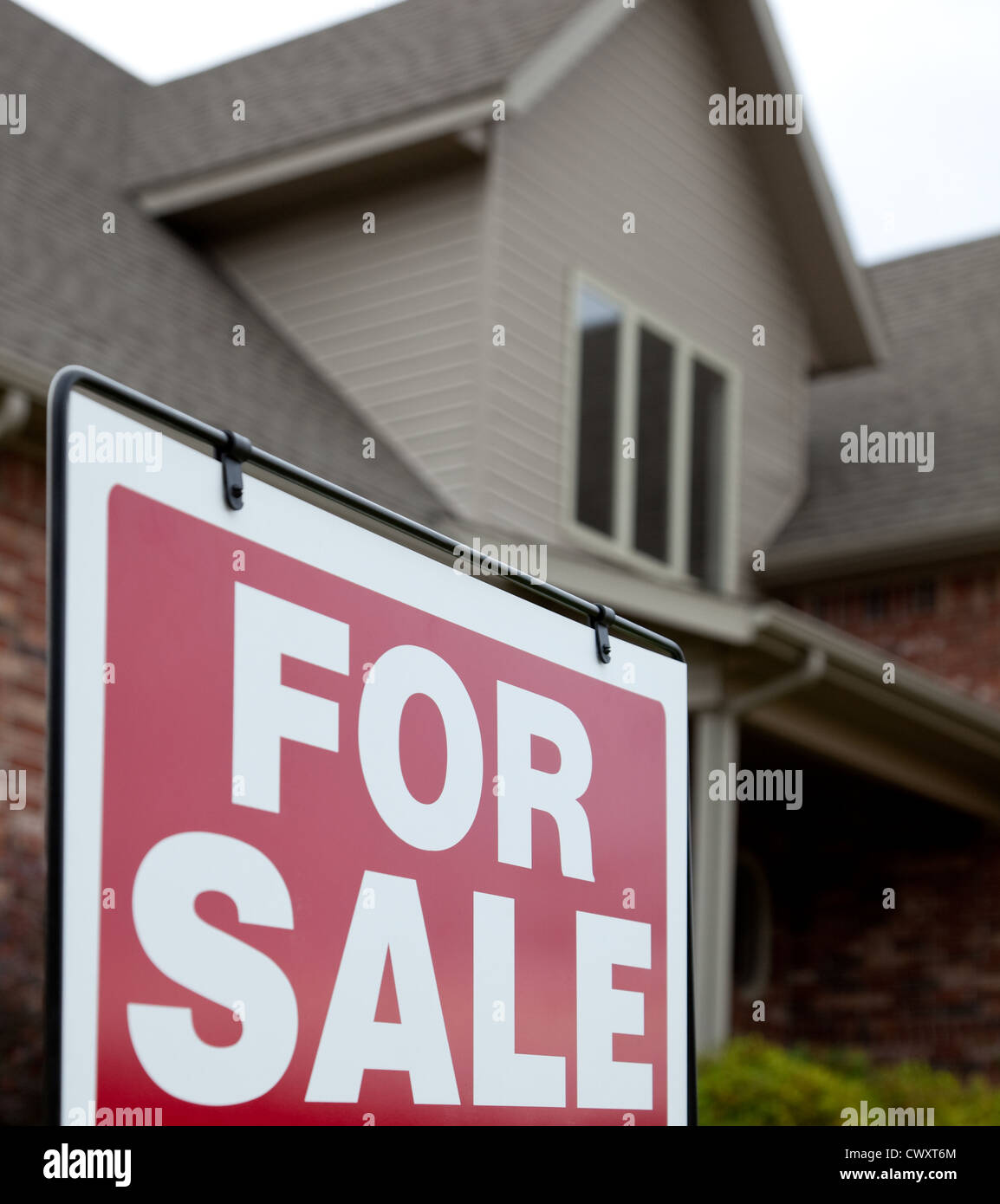 For Sale sign with a house in the background Stock Photo - Alamy
