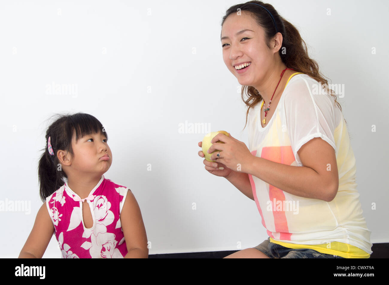 To give mom peevish little girl Stock Photo - Alamy