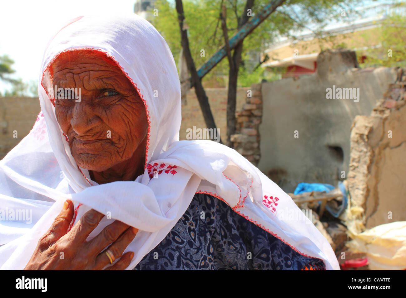 Old Refugee Woman assesses damages to her home caused by Floods in ...