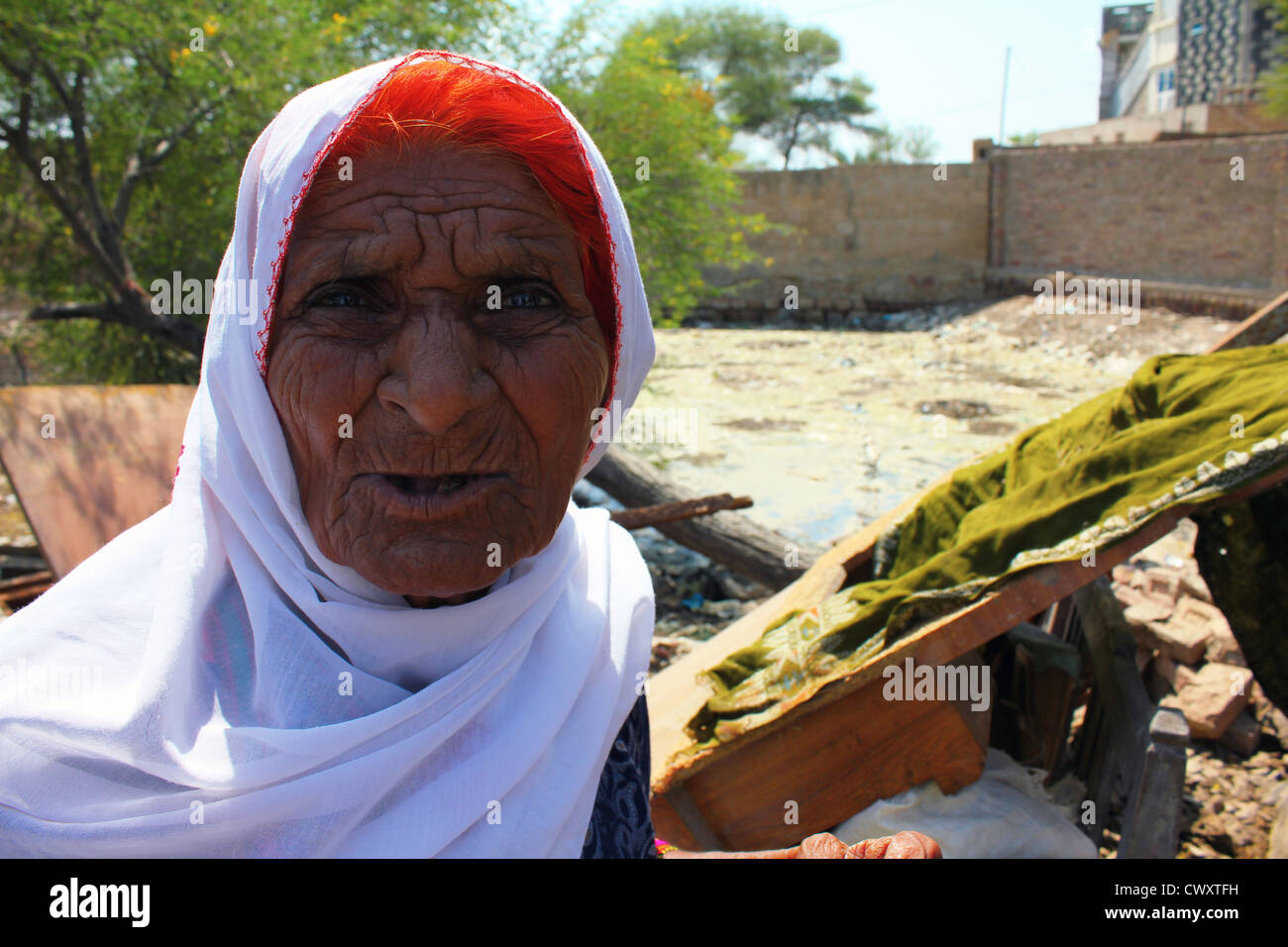 Old Refugee Woman assesses damages to her home caused by Floods in ...