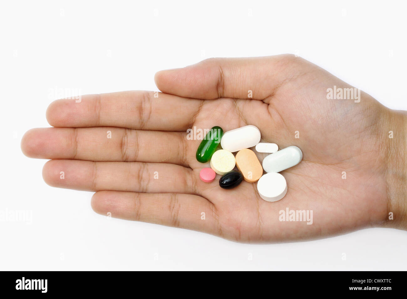 Hand with pills isolated on white background Stock Photo - Alamy