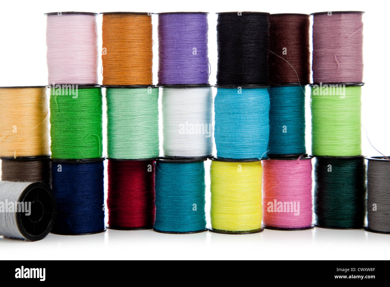 Assorted colored spools of thread on a white background Stock Photo - Alamy