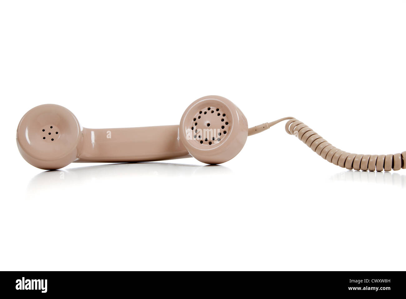 A beige telephone receiver on a white background Stock Photo - Alamy