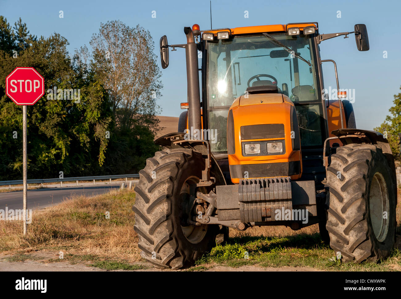 New orange tractor parked at the end Stock Photo - Alamy