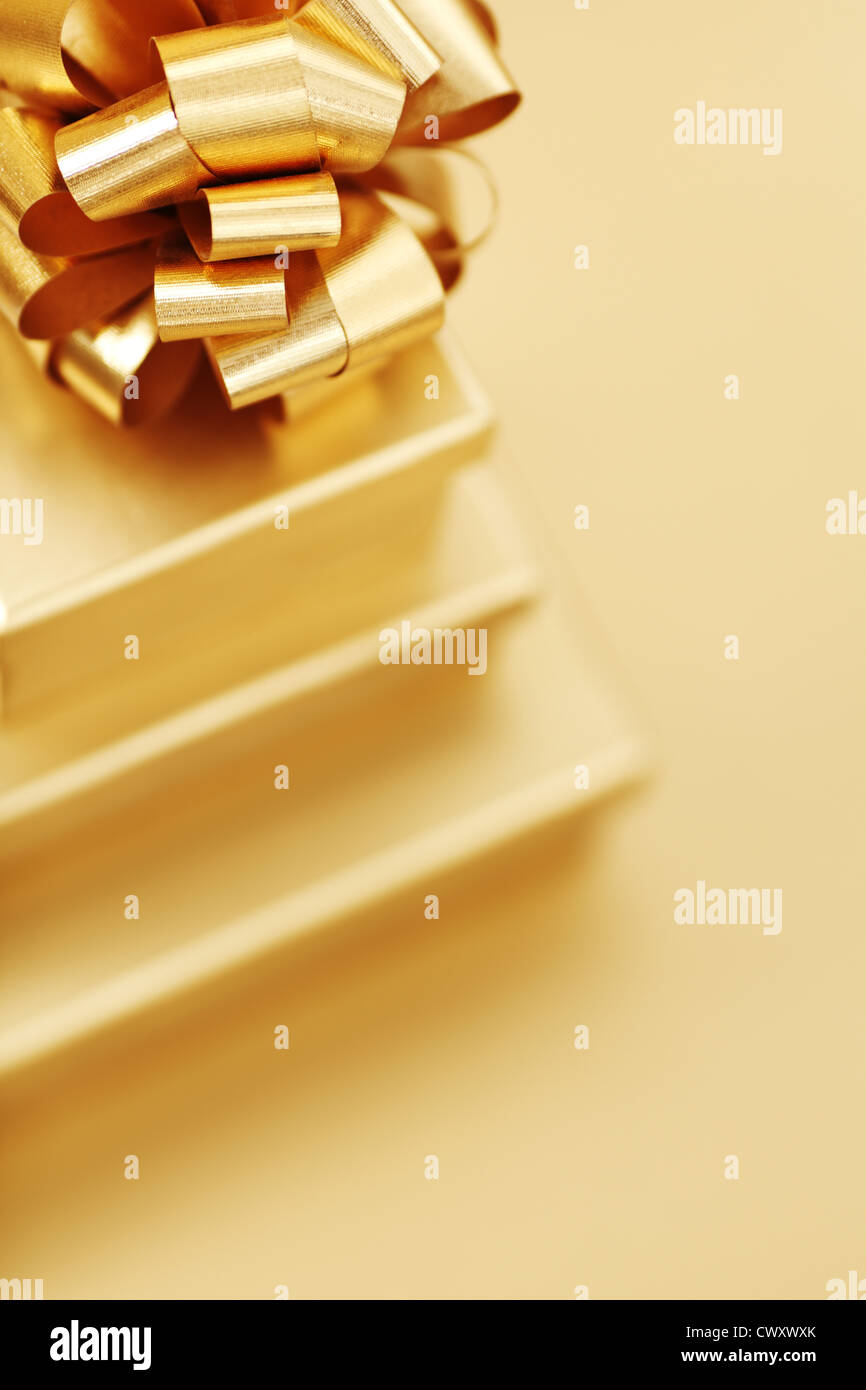 golden christmas gifts on gold background Stock Photo - Alamy